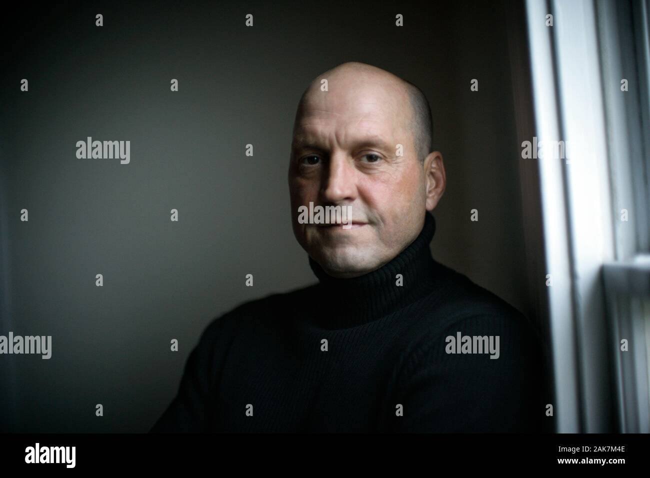 Mature man standing by window hi-res stock photography and images - Alamy