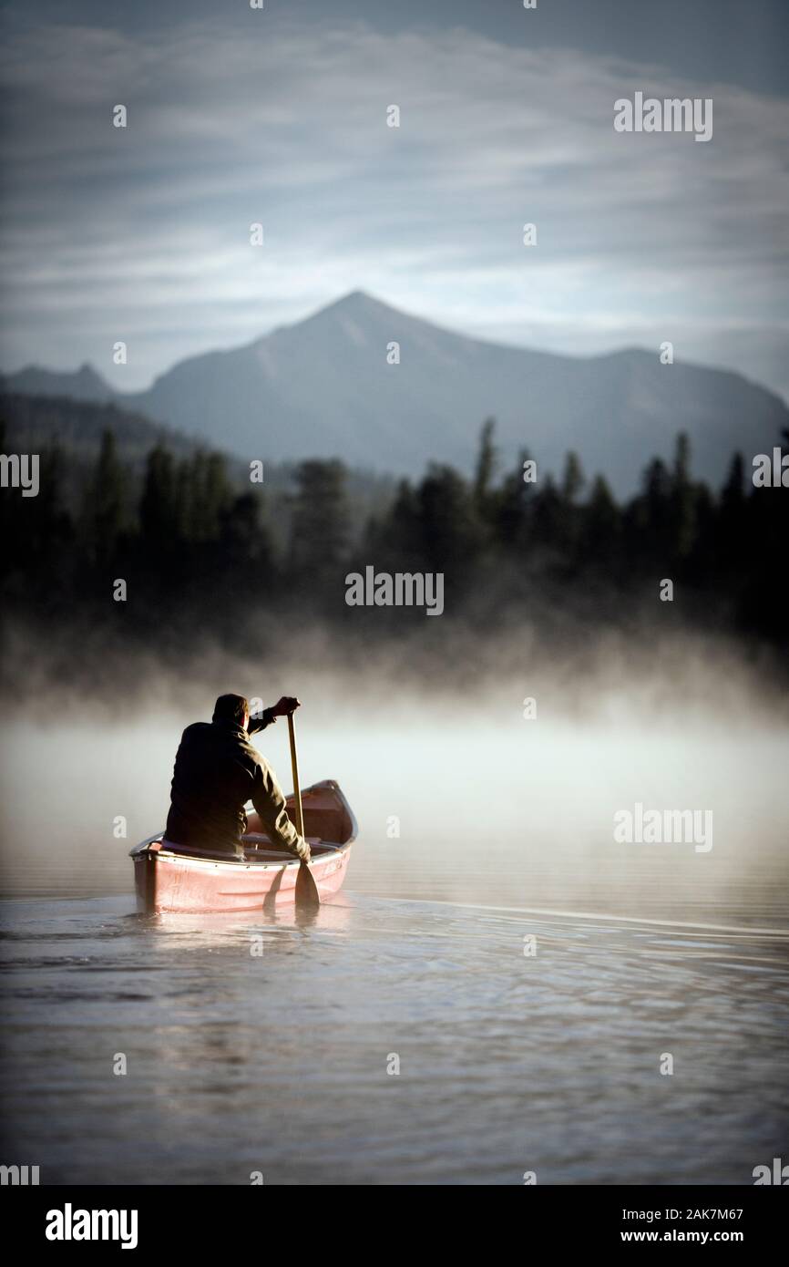 Rear view of a man rowing a boat Stock Photo - Alamy