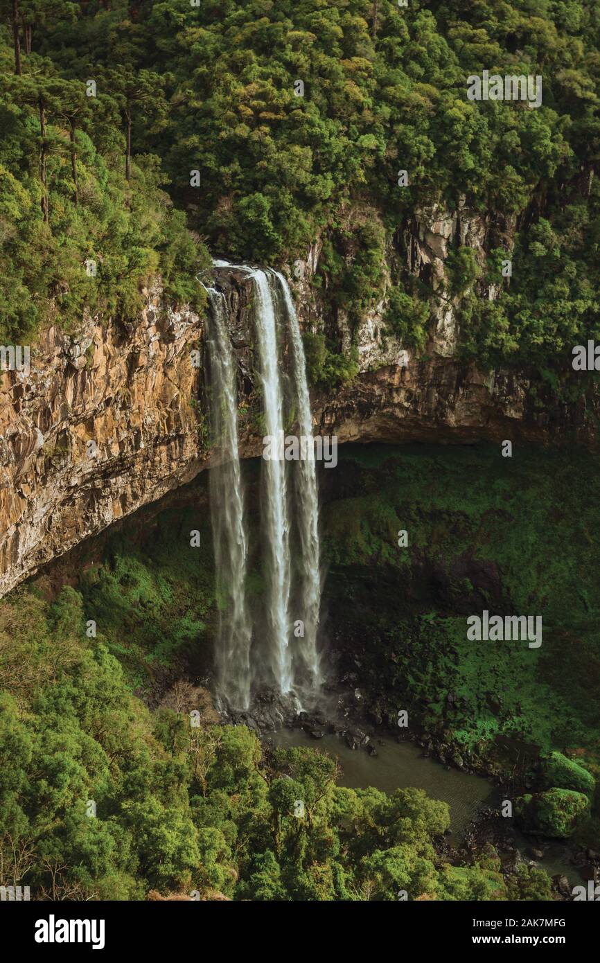 Caracol waterfall falling from rocky cliff in a forest from a park near ...