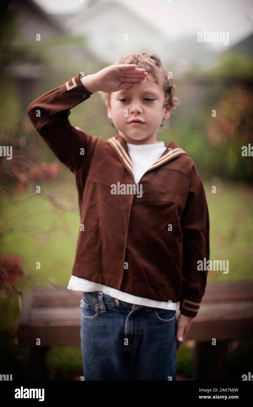 Portrait of a small boy saluting Stock Photo - Alamy