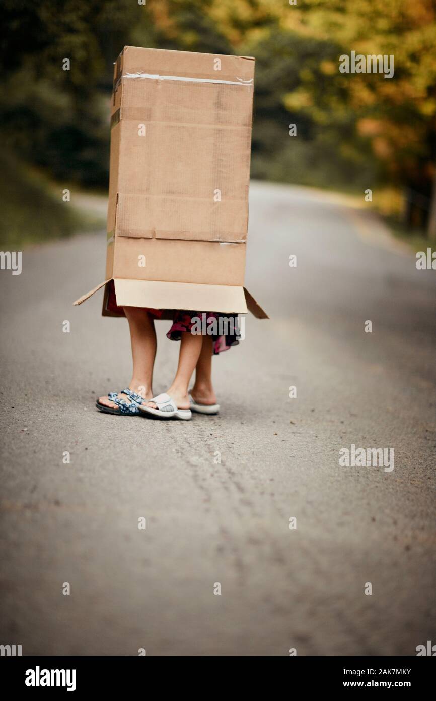 Two children seen trapped inside the box on the road Stock Photo - Alamy