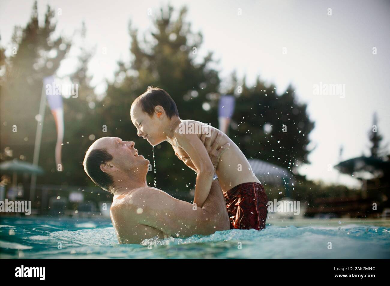 father and son play in pool Stock Photo - Alamy