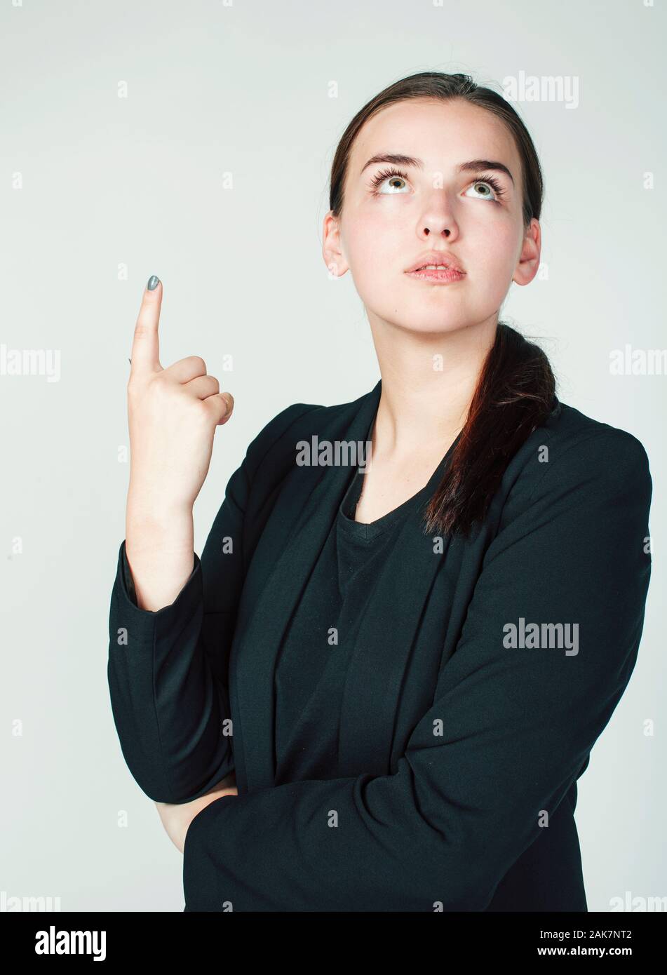 young pretty girl pointing and gesturing on white background, business ...
