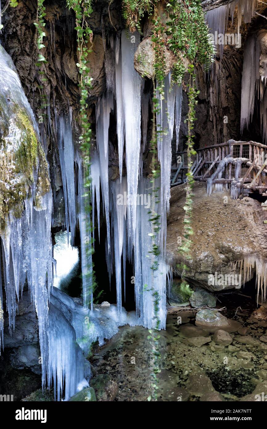View of stalactites and stalagmites of ice at the entrance of a cave ...