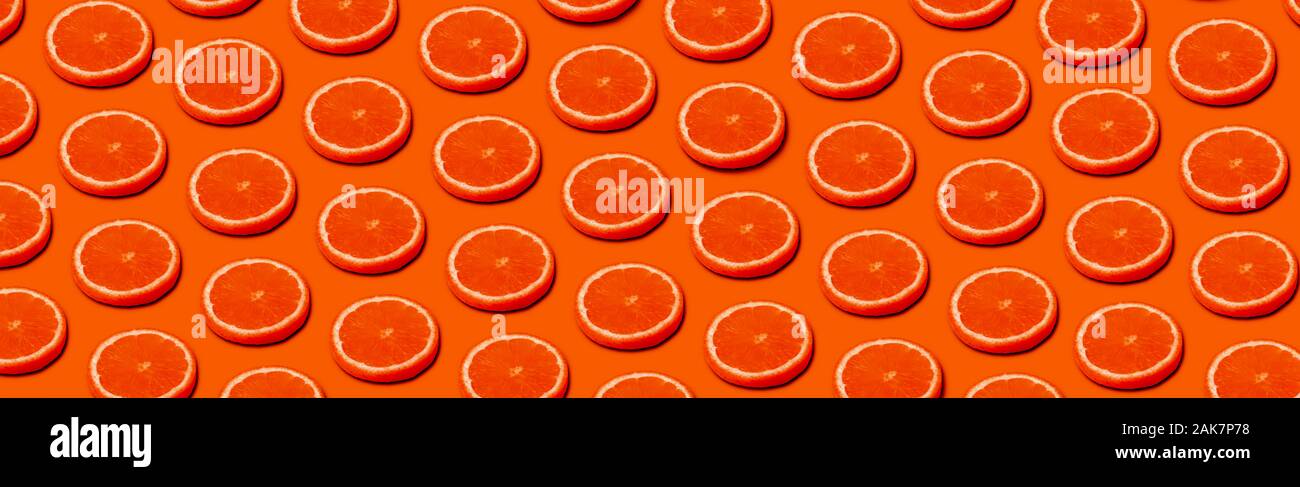 pattern with orange citrus fruits on a orange background, panoramic ...