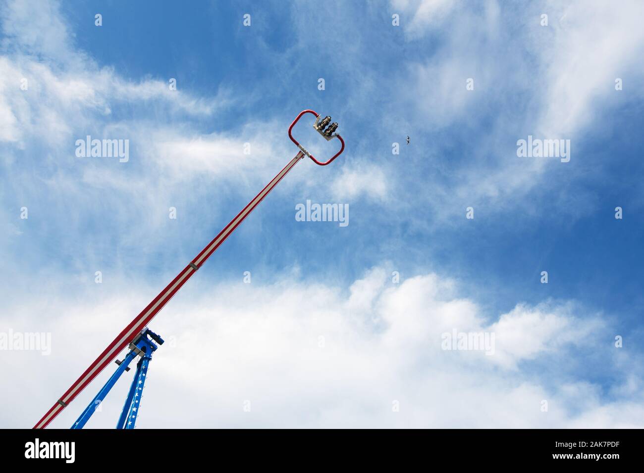 People ride on the extreme carousel on blue sky background, summer fun ...