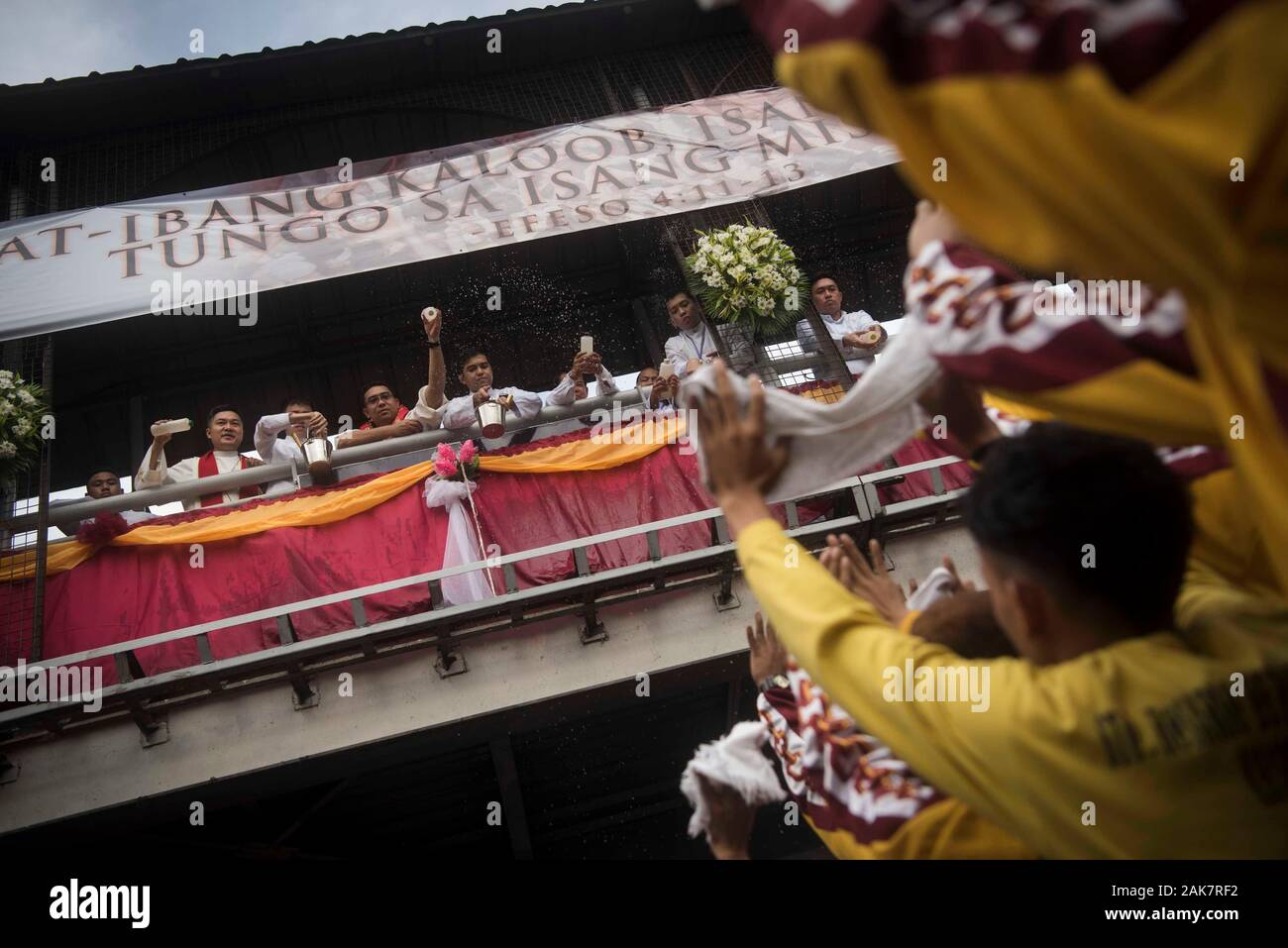 Priests sprinkle holy water on the crowd during the parade. Thousands ...