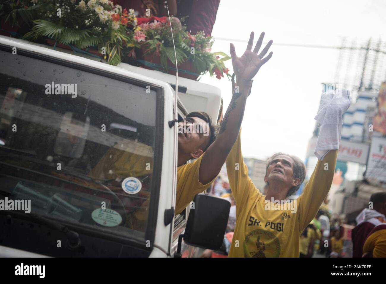 Catholic devotees react as priests sprinkle holy water on the crowd ...