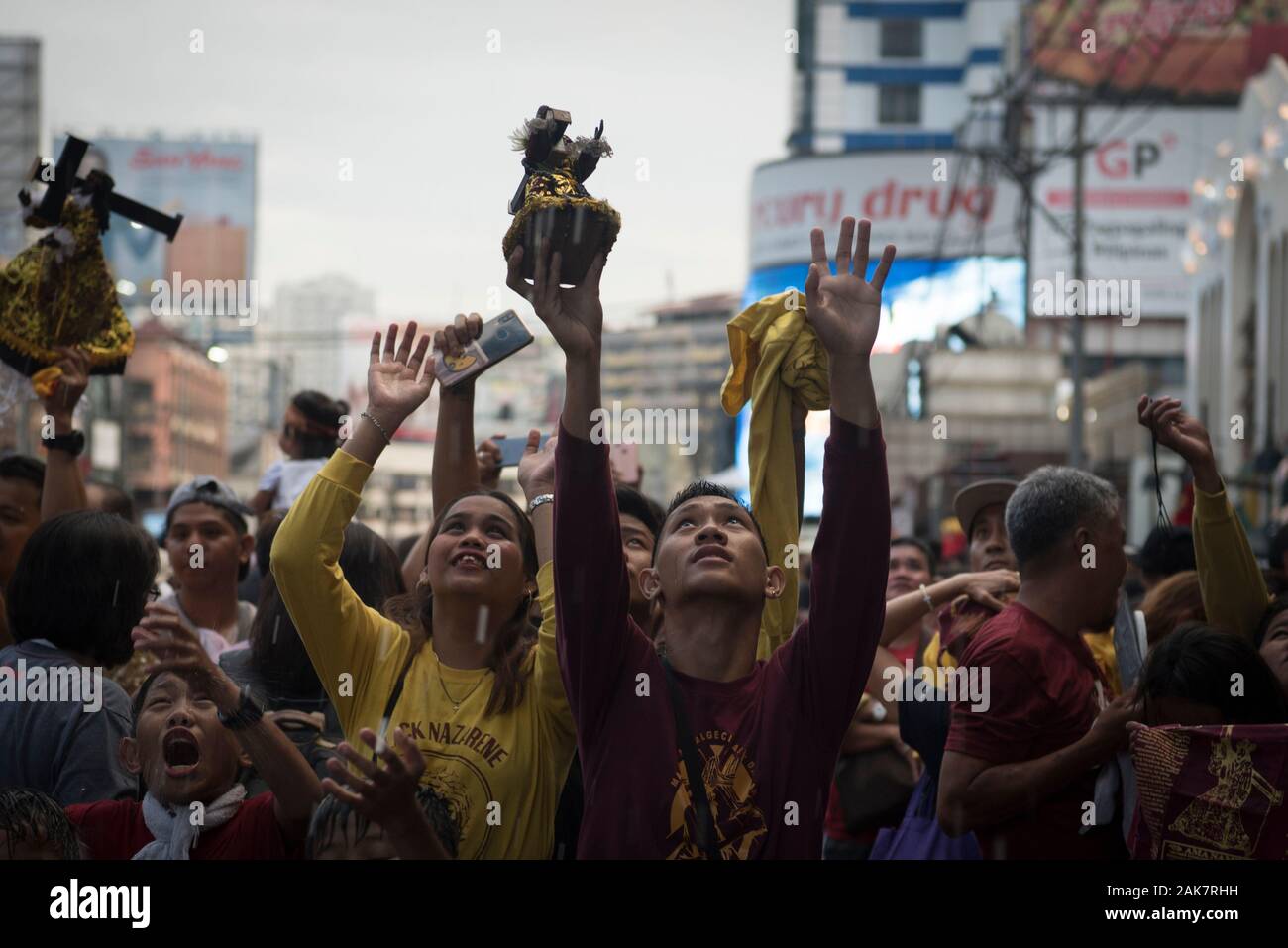 A man lifts a replica of the Black Nazarene sculpture during the parade ...