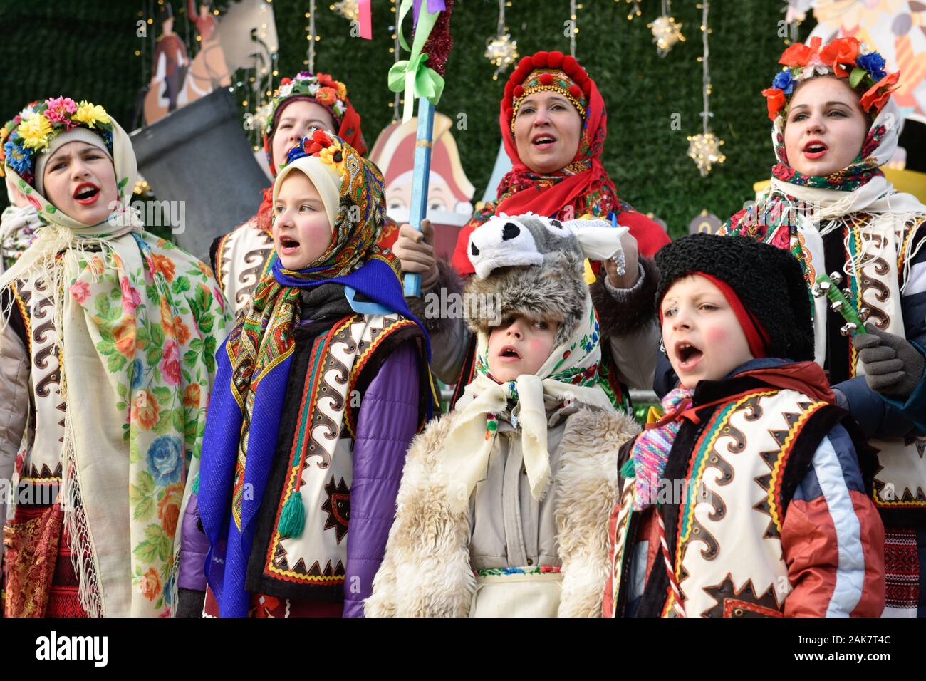 People dressed in traditional costumes singing Christmas carols.Members ...