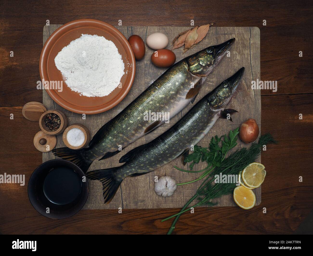 Fresh fish with ingredients for cooking. Raw pike with herbs, spices ...