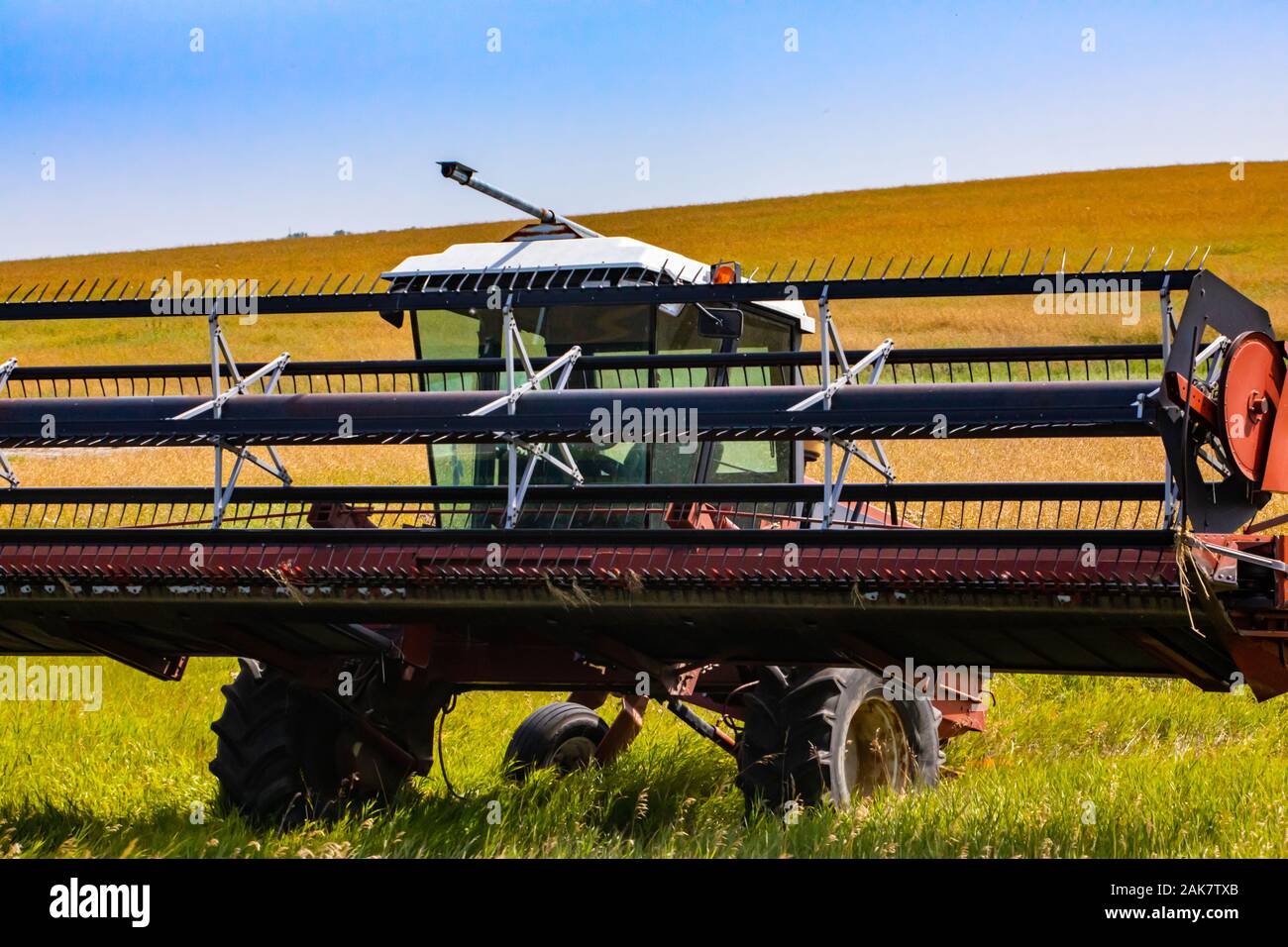 Close up details of a retro combine harvester attached to a small ...