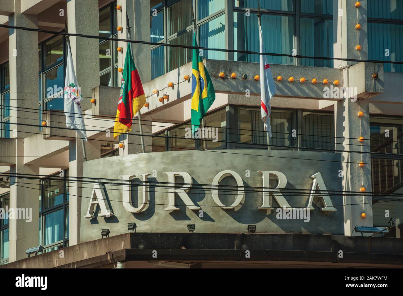 Company signboard and flags on the facade of Aurora Winery building at ...