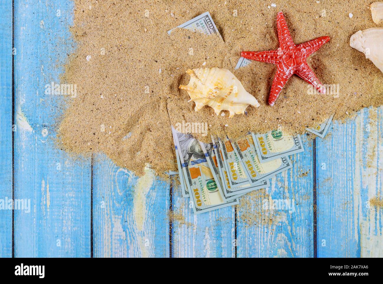 Vacation and travel concept Starfishes and seashells on cash money ...