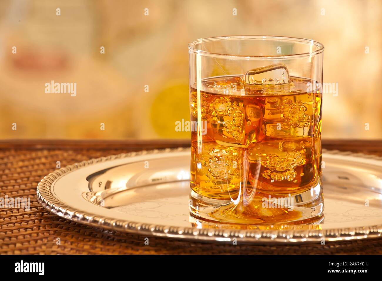 whisky glass on silver platter on wooden table with ancient world map ...