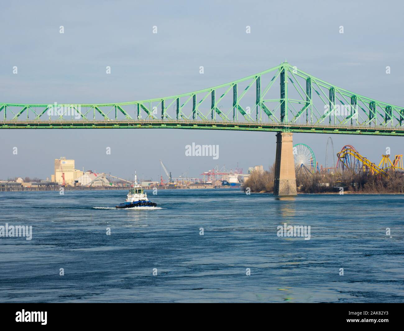 Boat on St-Lawrence river with the Jacques-Cartier bridge in background ...