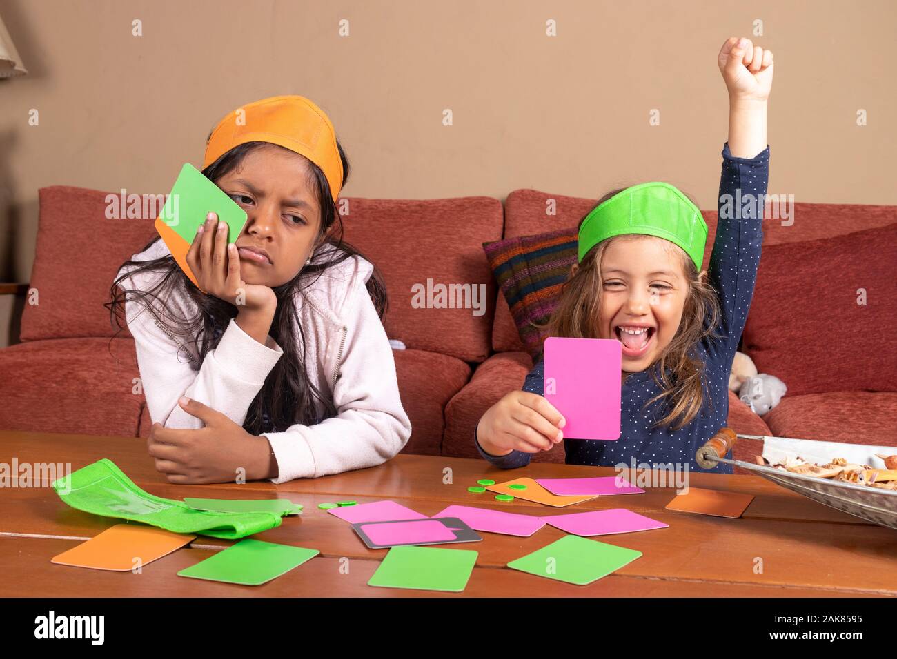 Girl celebrates after winning her card game Stock Photo - Alamy