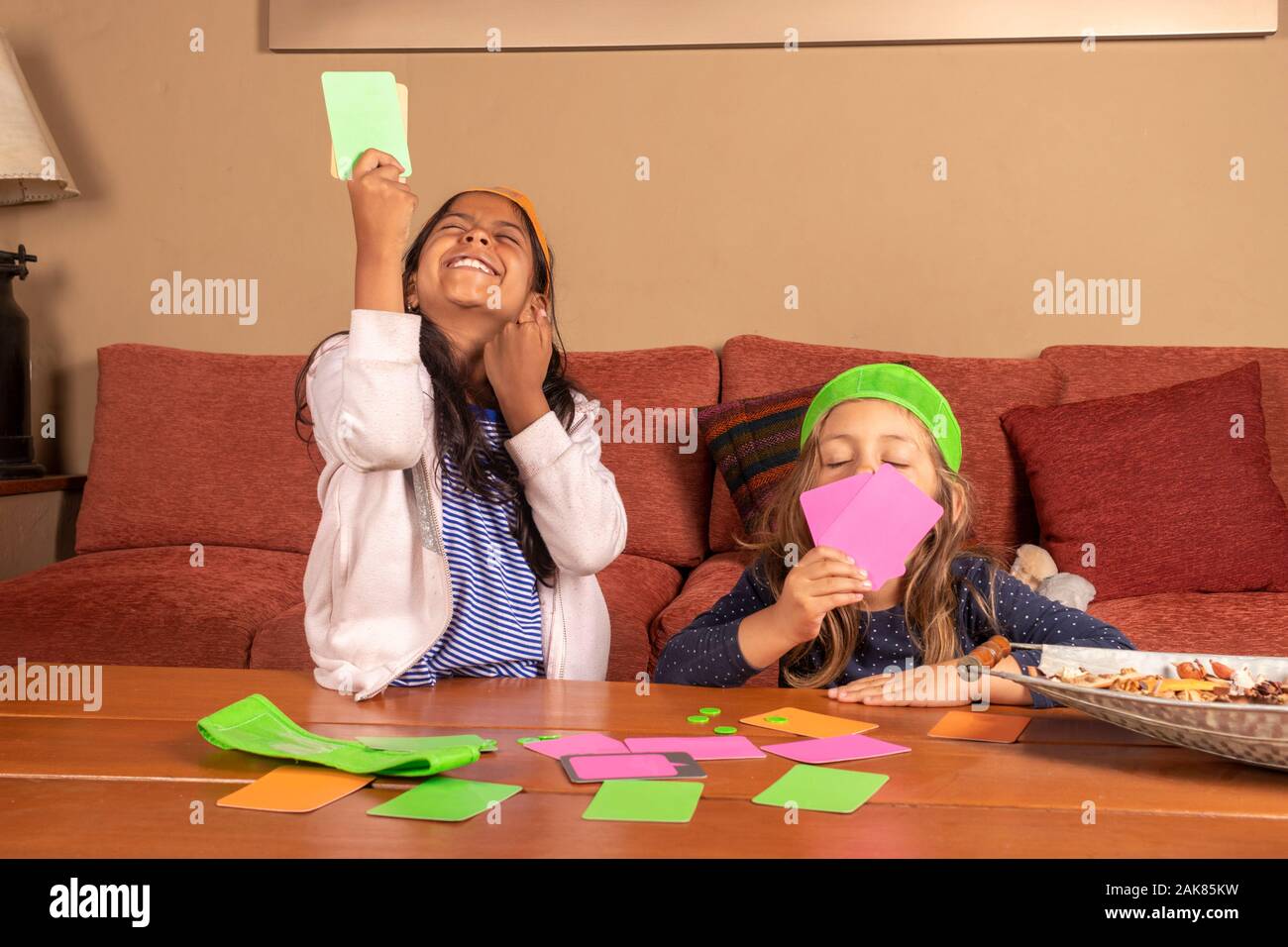 Girl celebrates after winning her card game Stock Photo - Alamy
