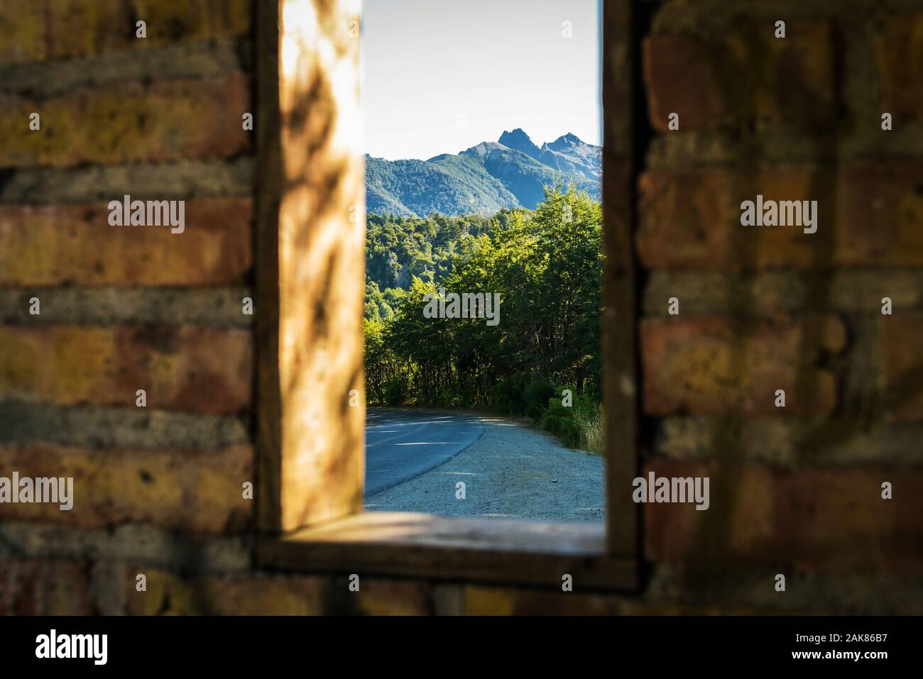 Forest and Andes mountains through a window in a wall in Patagonia ...