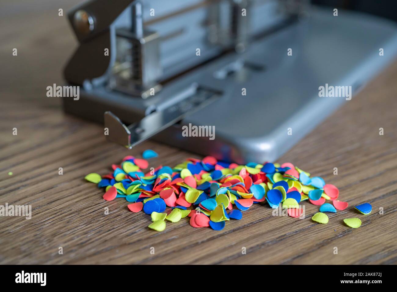 Paper Chads produced by punching holes in a sheets of colored paper ...