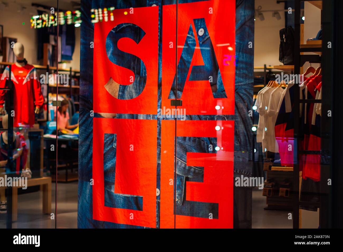 Storefronts with sale sign behind the glass window Stock Photo - Alamy