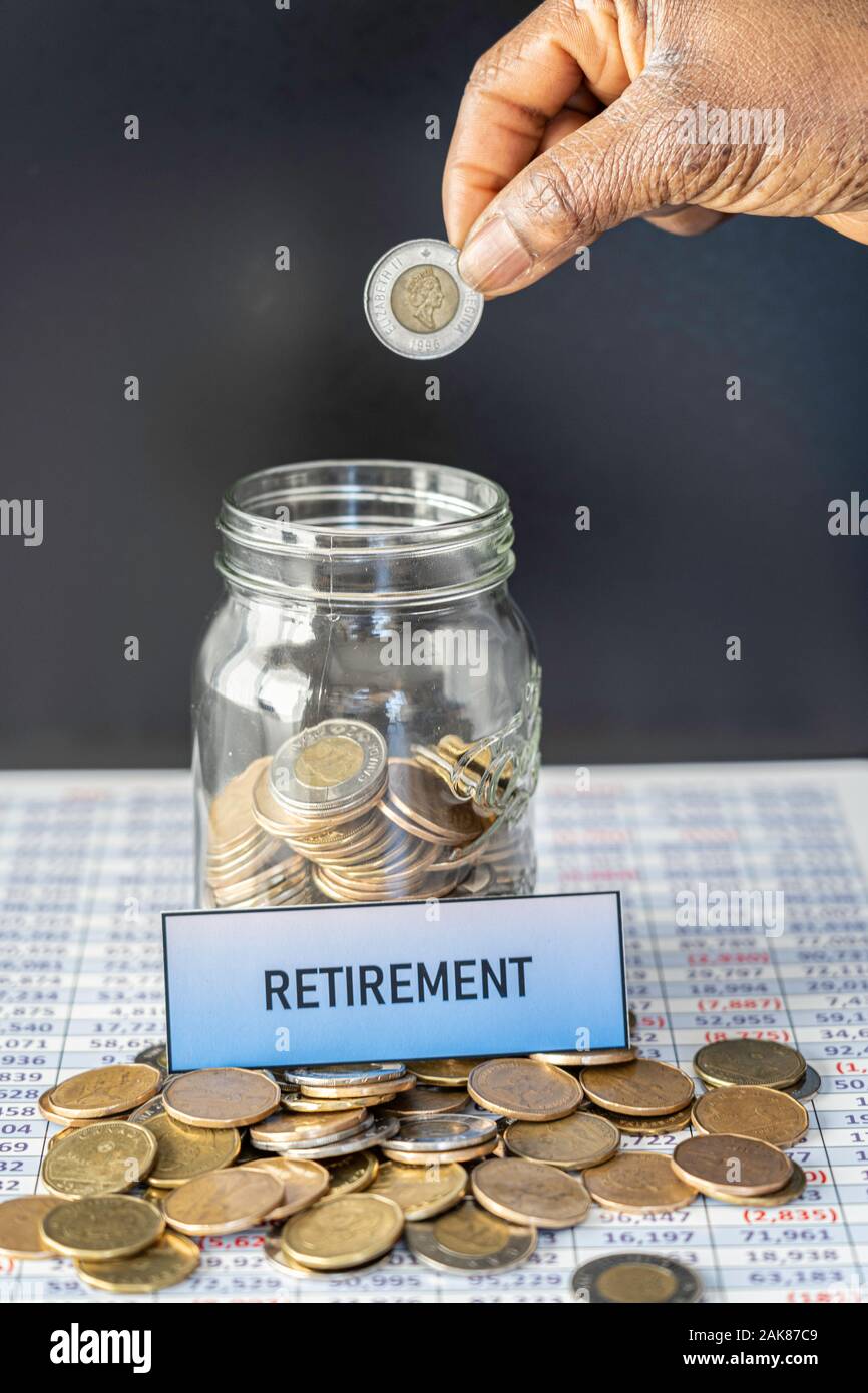 Jar of Coins Showing Retirement savings on a spreadsheet Stock Photo ...