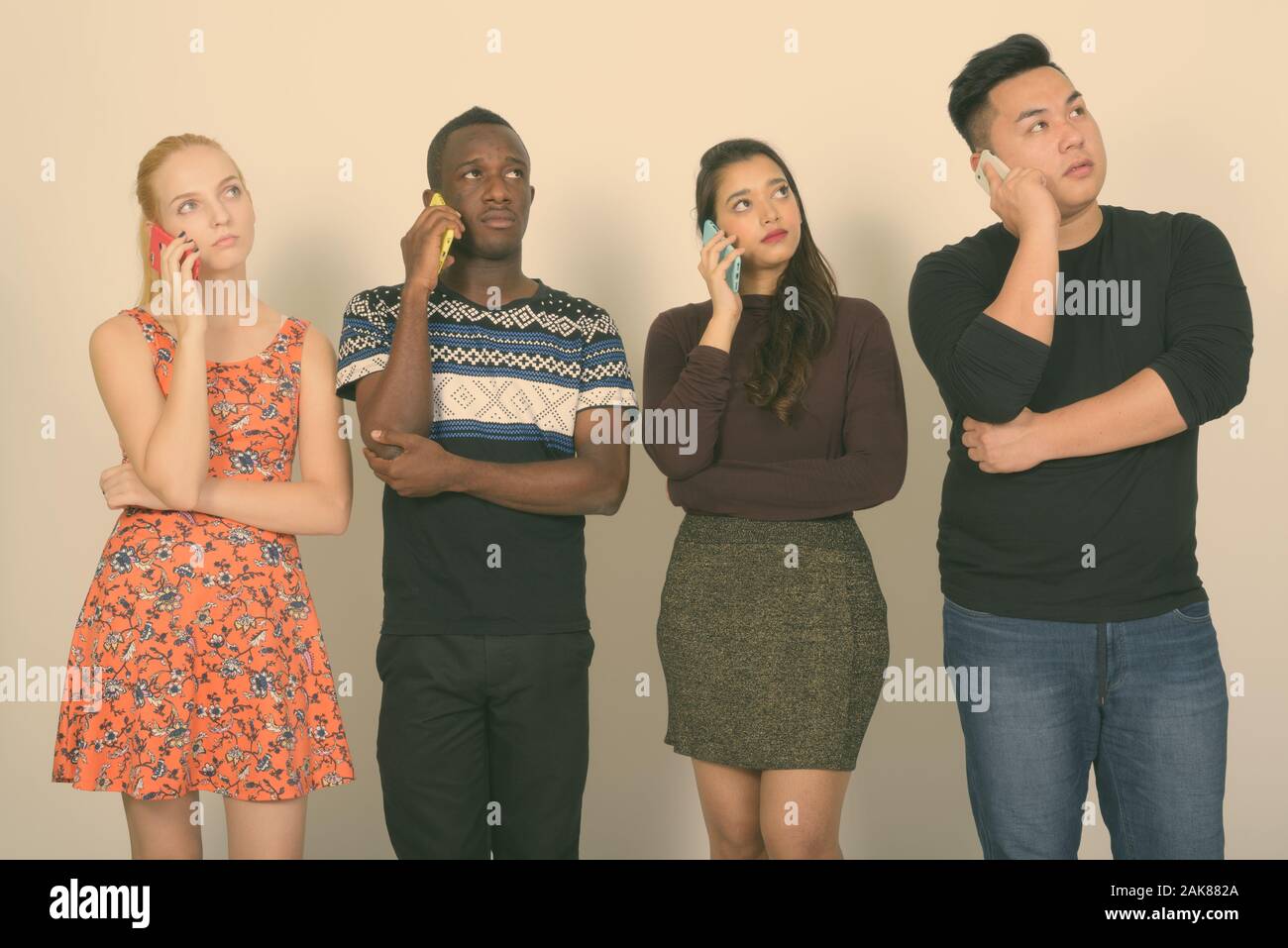 Studio shot of diverse group of multi ethnic friends thinking while ...
