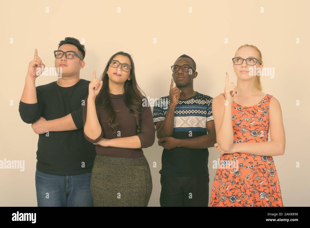 Studio shot of diverse group of multi ethnic friends thinking while ...