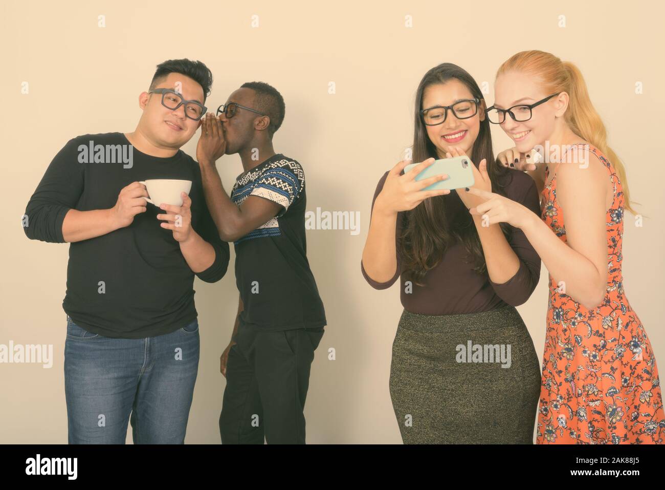Diverse group of four friends in a coffee house Stock Photo - Alamy