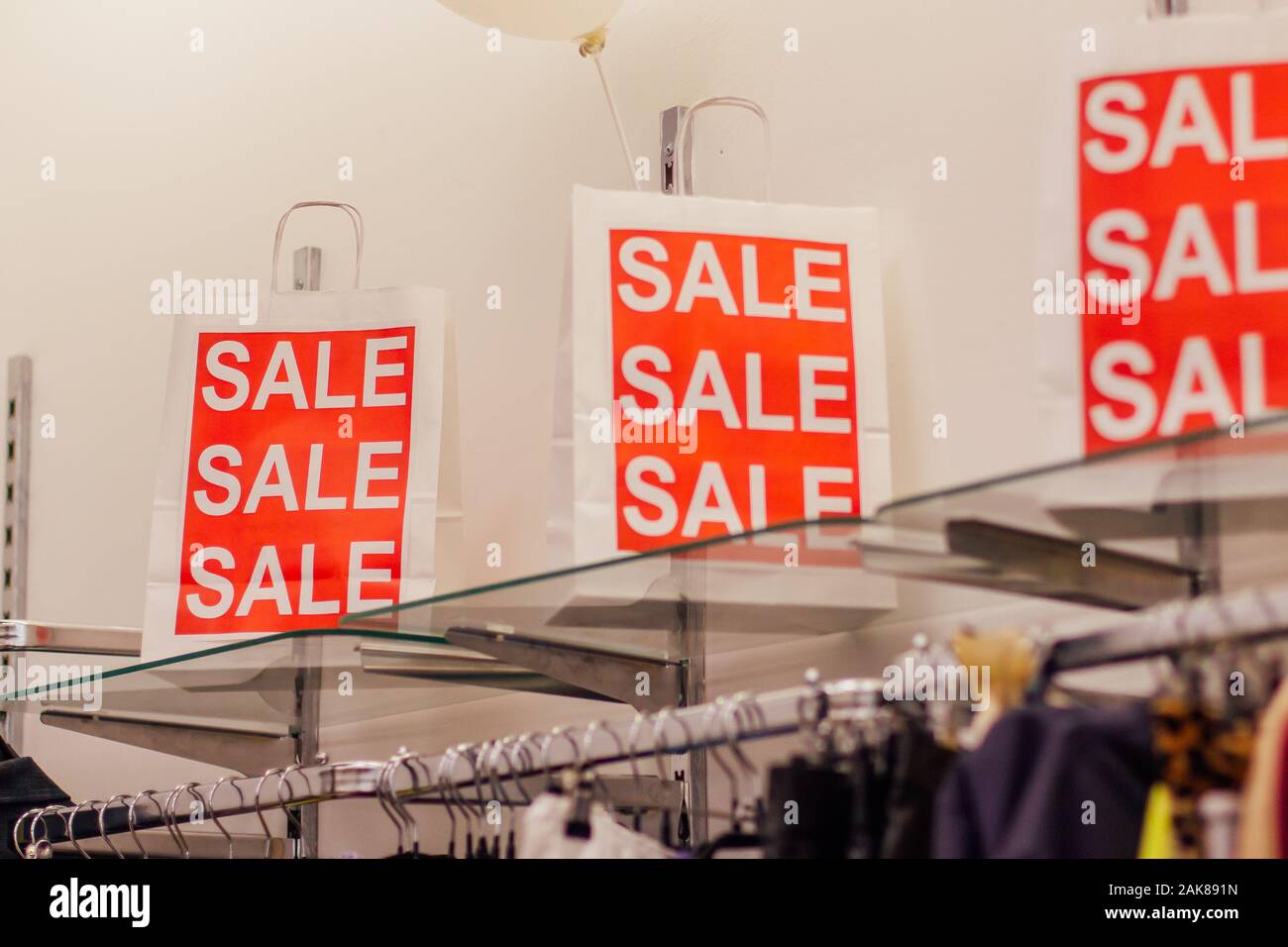 Red sale sign inside a shop Stock Photo - Alamy