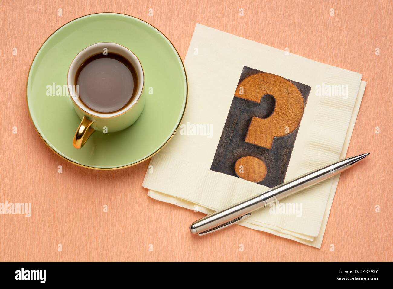 question mark in vintage letterpress wood type on a napkin with coffee ...