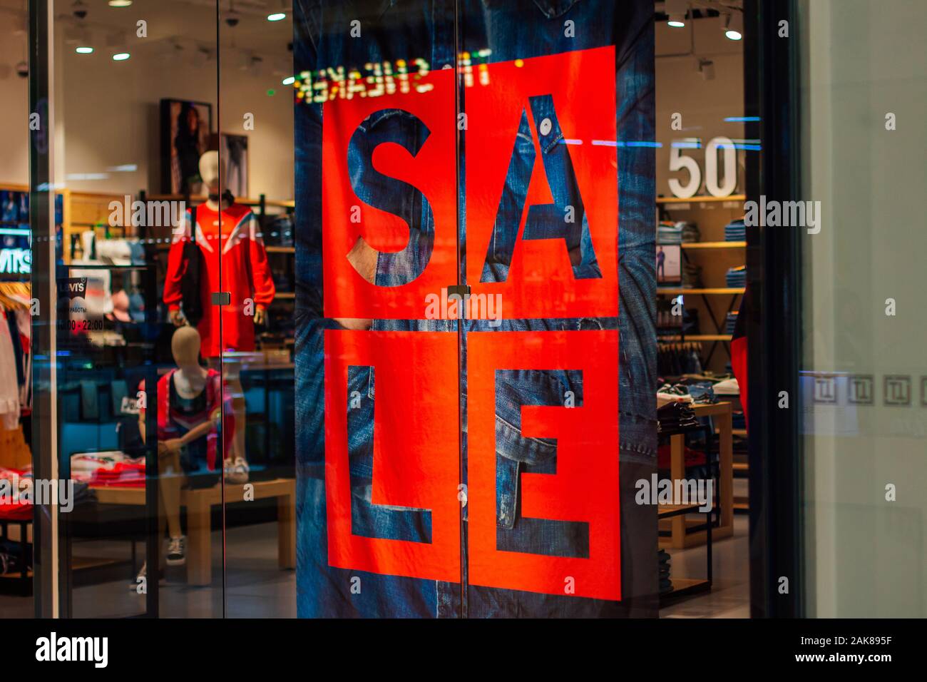 Storefronts with sale sign behind the glass window Stock Photo - Alamy