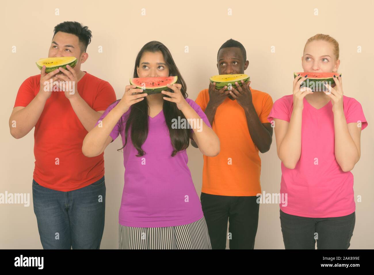Studio shot of diverse group of multi ethnic friends thinking while ...