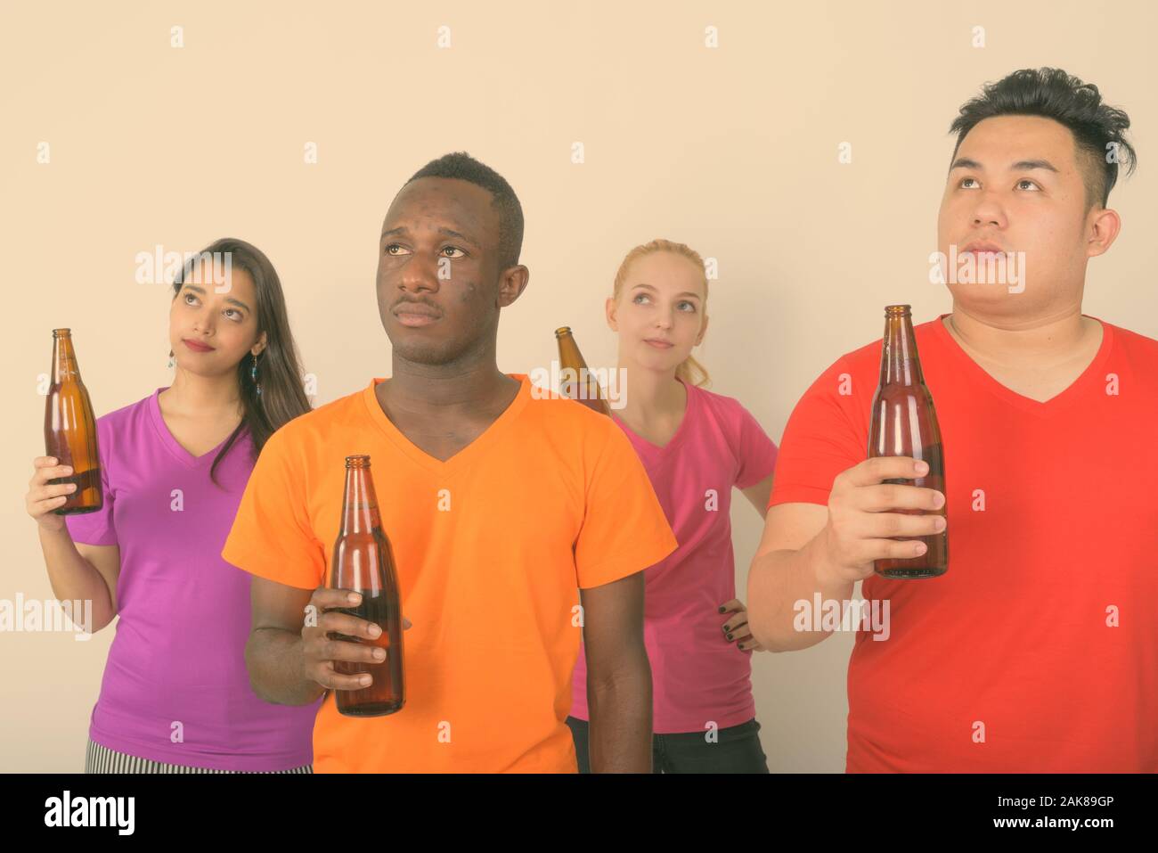 Studio shot of diverse group of multi ethnic friends thinking while ...