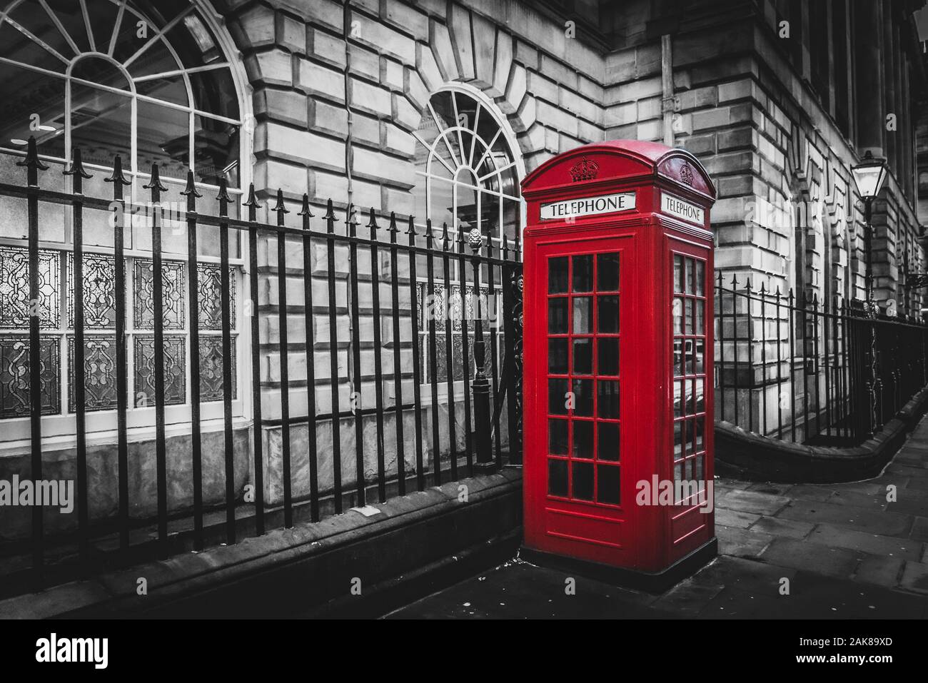 Traditional and iconic old red telephone box in London UK, isolated by ...