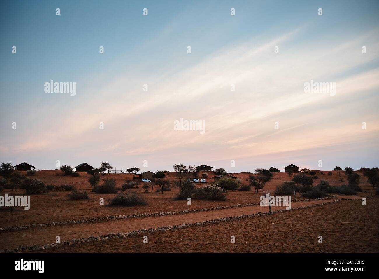 several houses and cars at an African ranch at evening Stock Photo - Alamy
