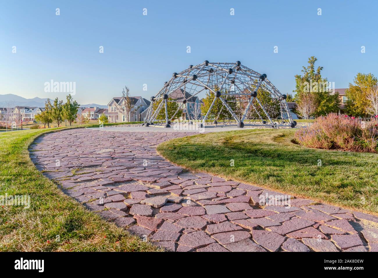 Neat landscaped park with dome climbing frame Stock Photo - Alamy