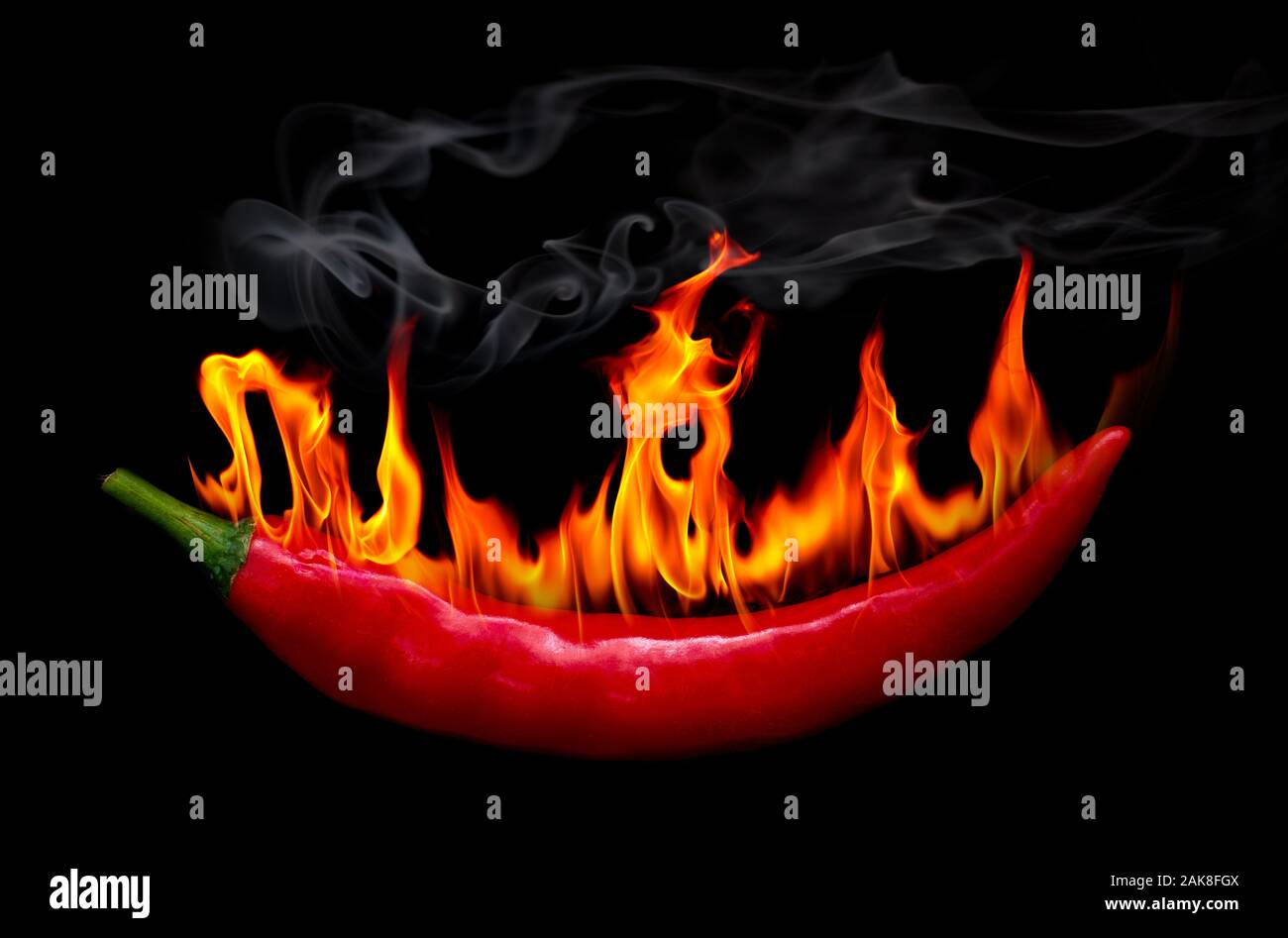 On fire red chili pepper at black background Stock Photo - Alamy