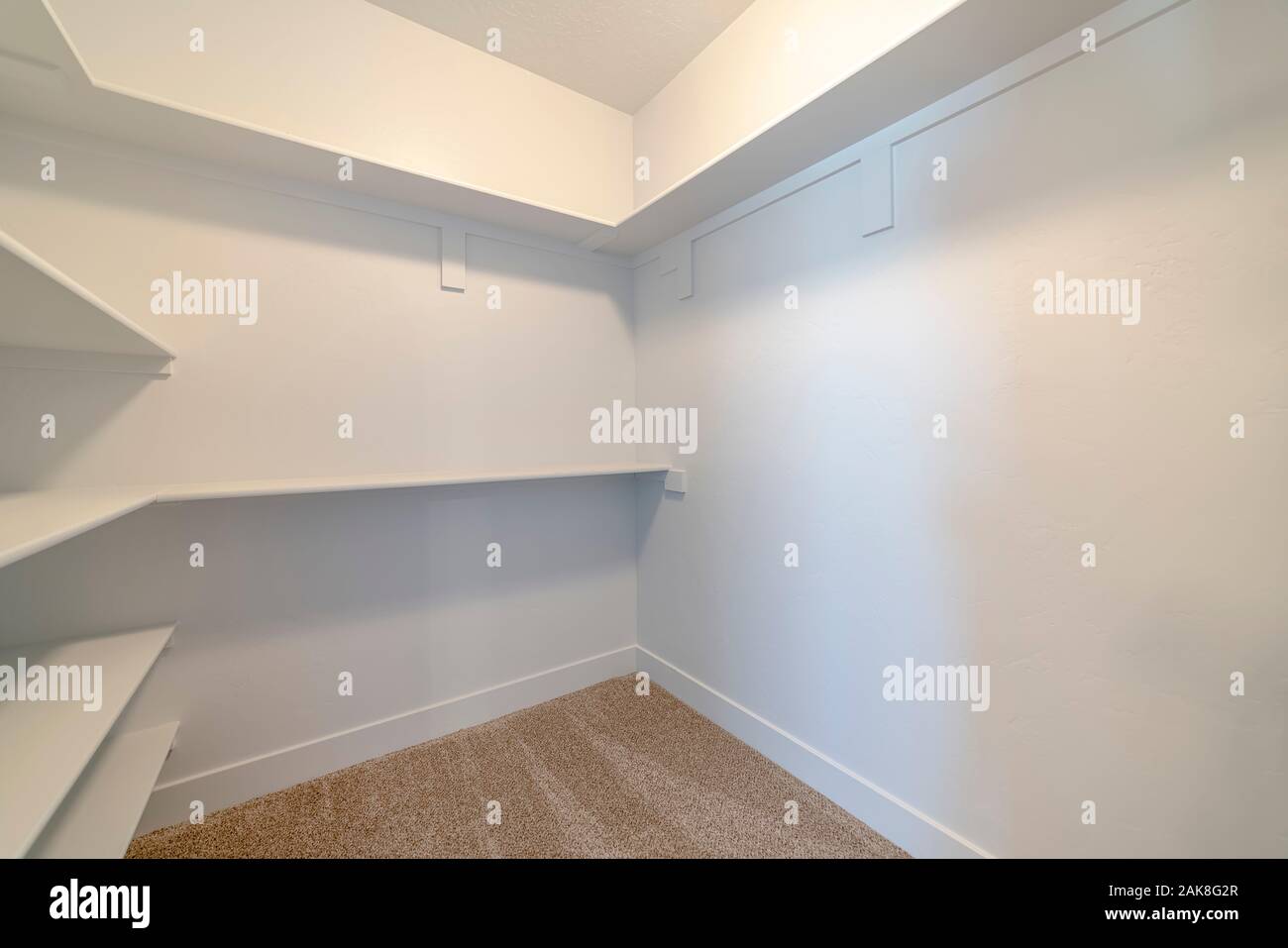 Empty white shelves inside a walk in cupboard Stock Photo - Alamy