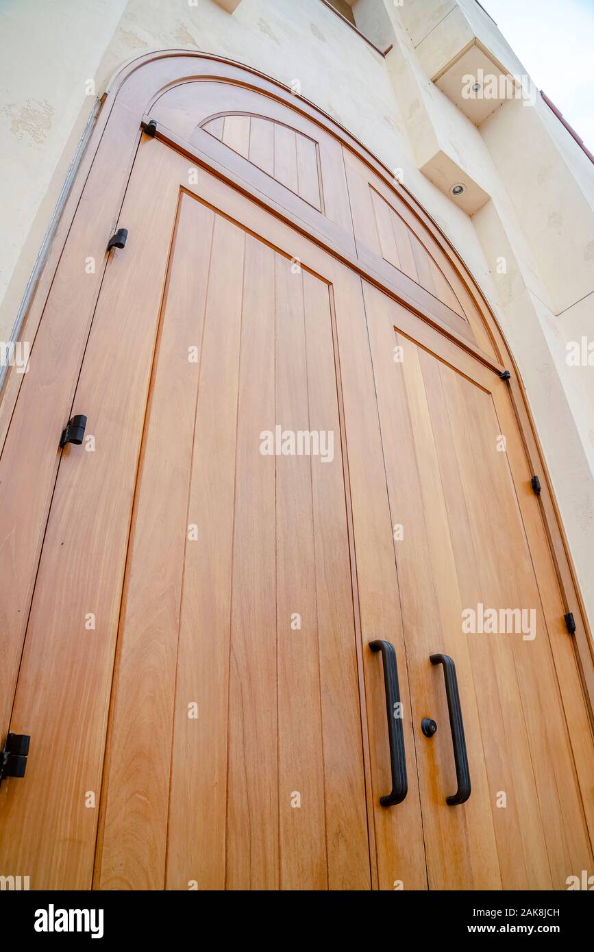 Low angle close up of an arched wooden door Stock Photo - Alamy