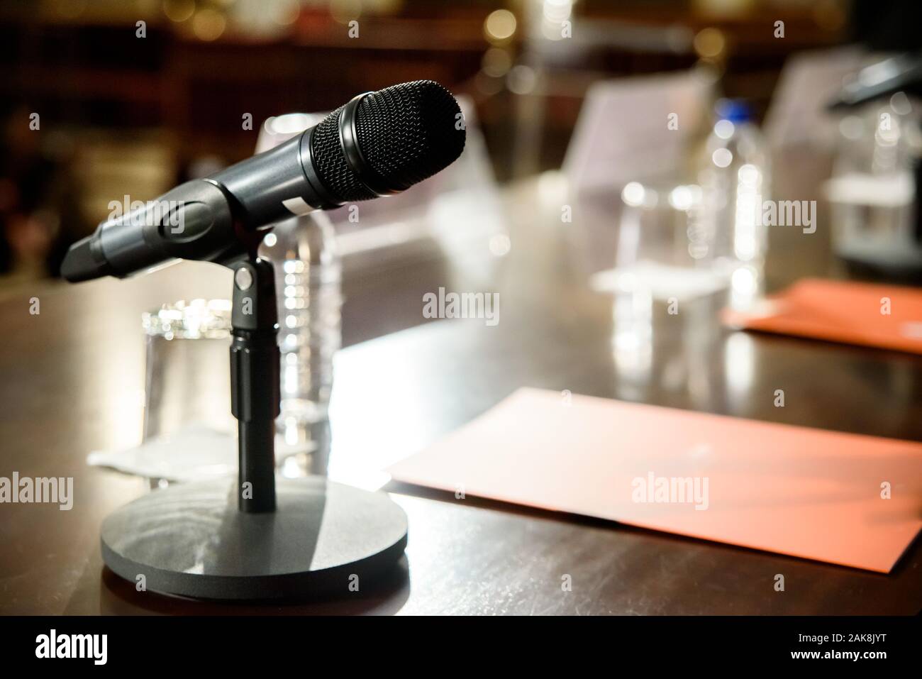 Wireless microphone on a wooden table in a conference room, with no one ...