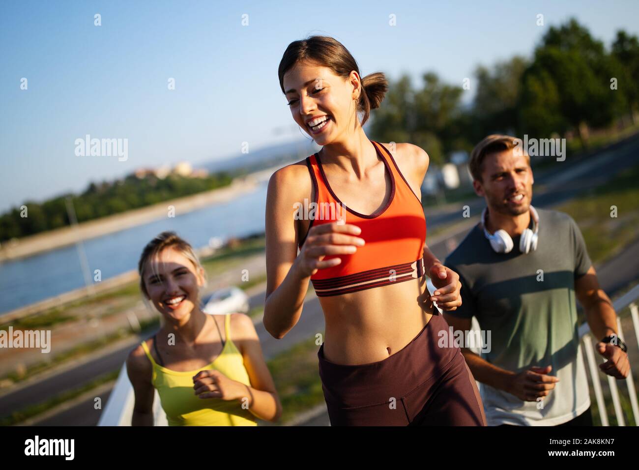 Fitness, sport, people and running concept. Happy fit friends running ...