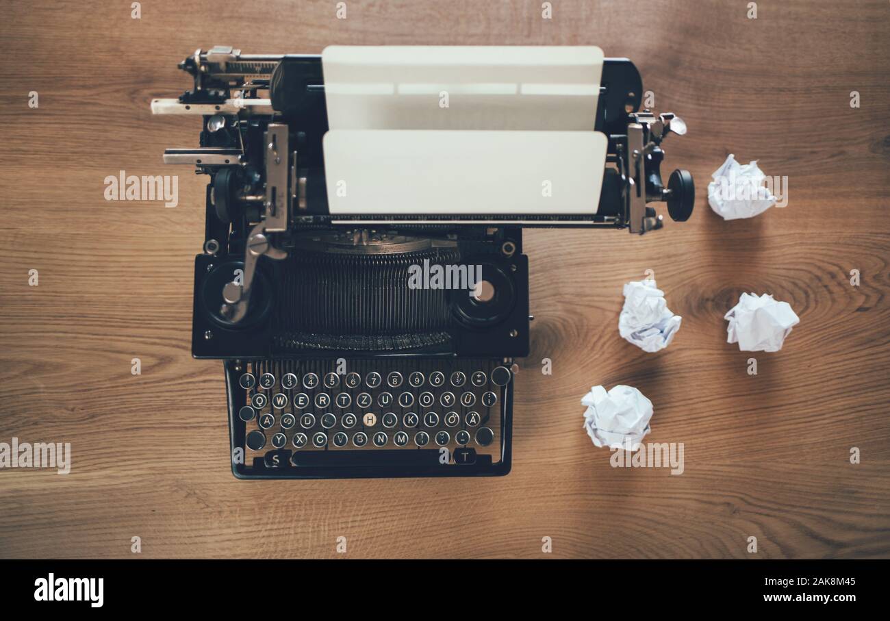 Vintage writer's desk with typewriter with crumpled papers Stock Photo ...