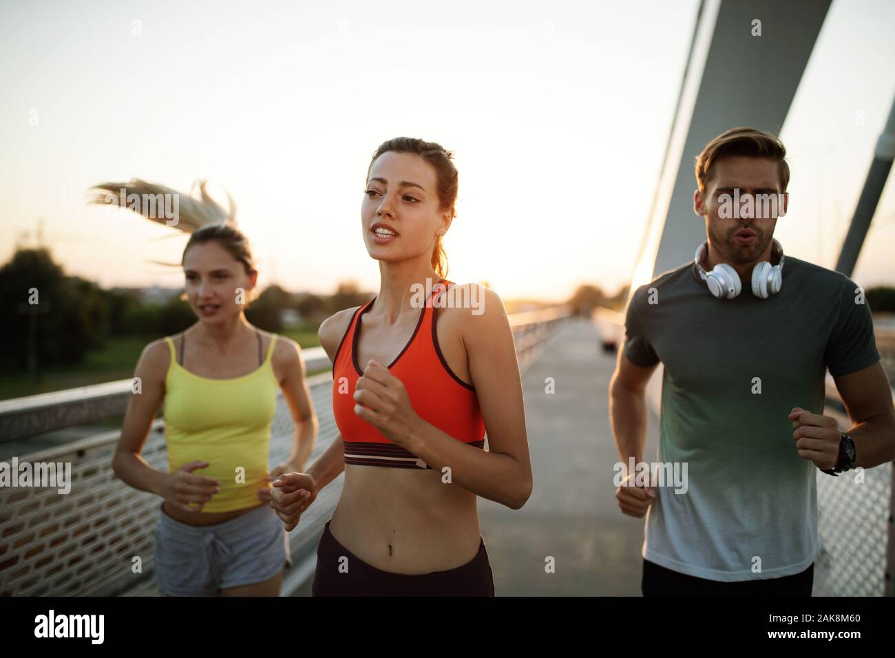 Fitness, sport, people and running concept. Happy fit friends running ...