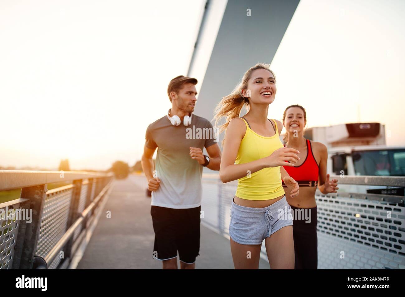 Fit happy friends jogging and running together outdoor in city Stock ...