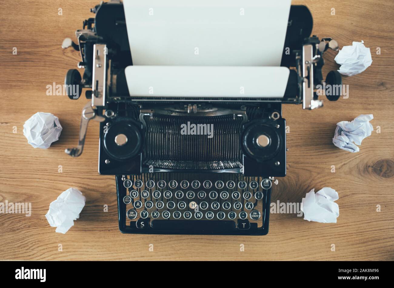 Vintage writer's desk with typewriter with crumpled papers Stock Photo ...