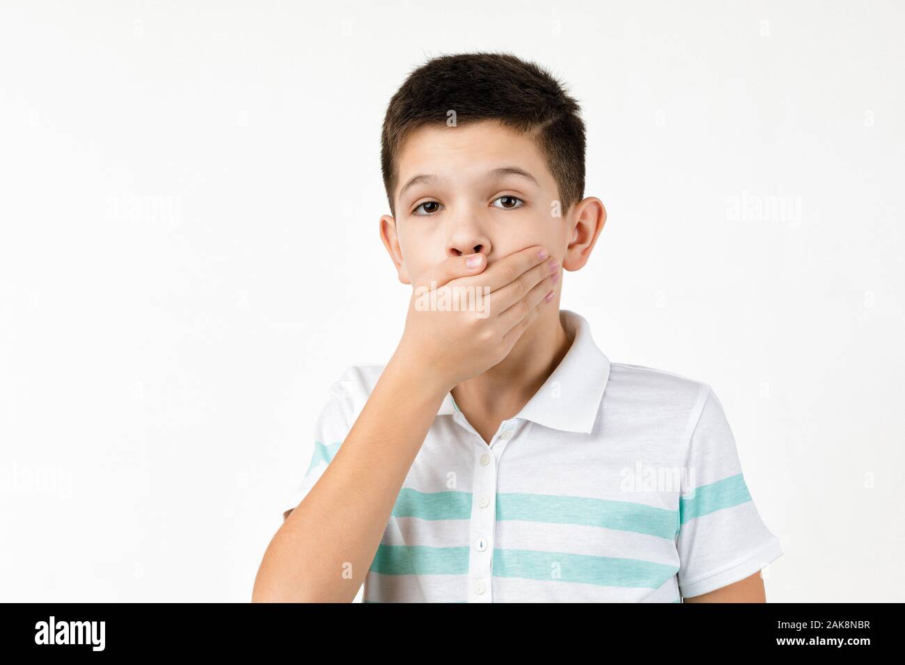 shocked surprised little child boy in t-shirt looking to camera on ...