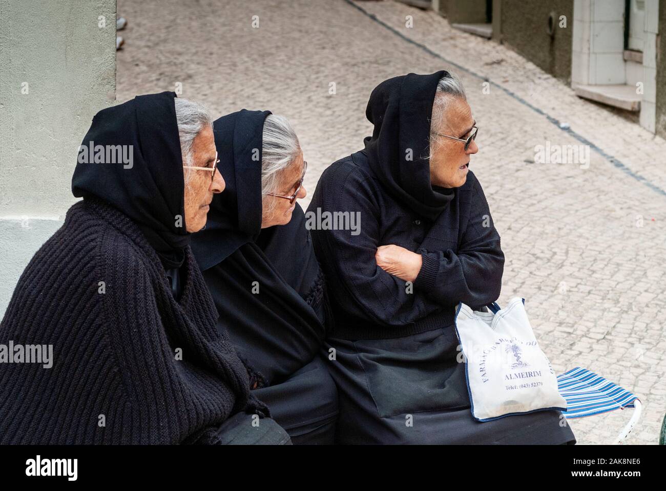 old women in typical black clothes in Nazare, Portugal Stock Photo - Alamy