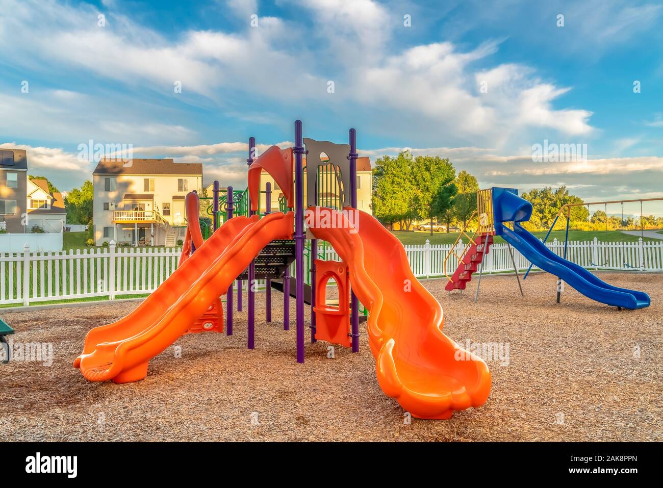 Bright orange and blue slides at a colorful fun playground for children ...