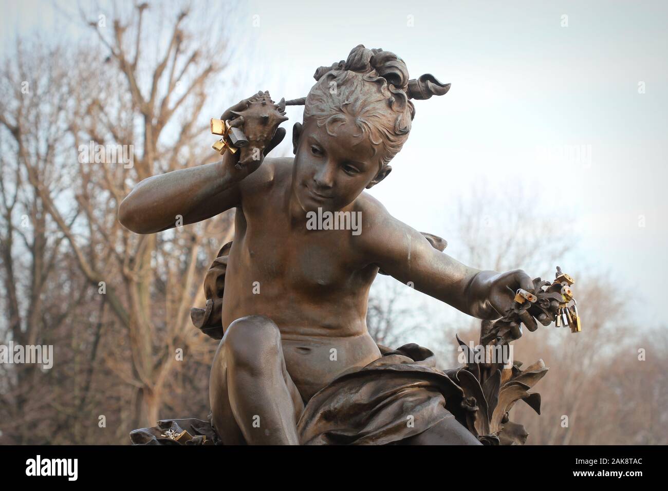 A statue of a girl listening a shell decorates the Le Pont Alexandre ...